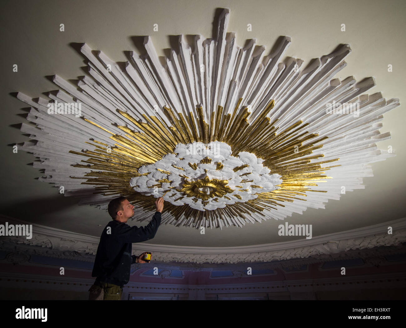 Restorer Andre Baer paints the stuccoed ceiling of the palace chapel ...