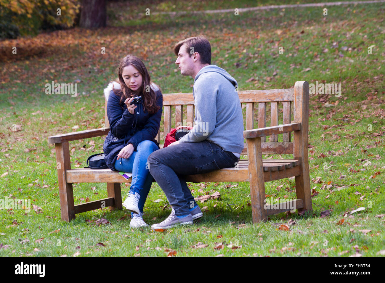 Young Couple Sat On Bench High Resolution Stock Photography and Images ...