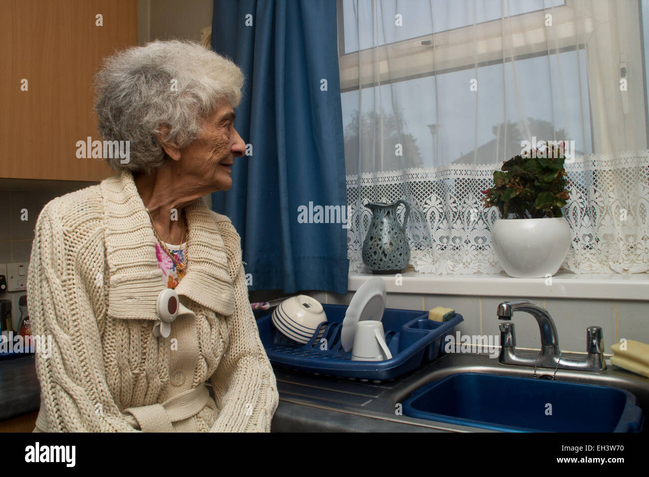 Elderly Alzheimer's Dementia sufferer looking out of the kitchen window ...