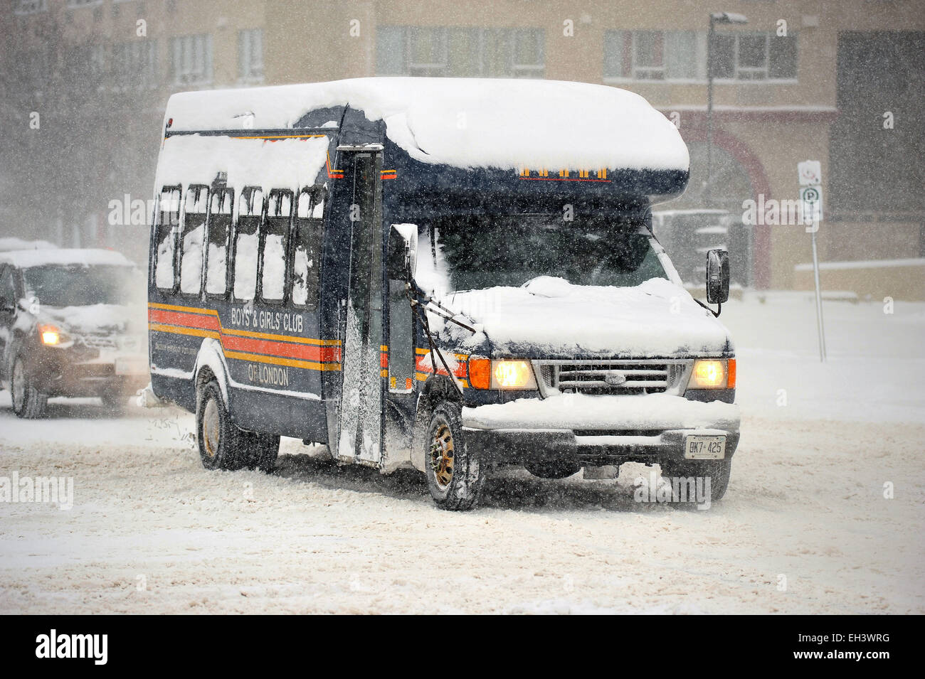 A bus covered in snow drives in snowy roads in Canada Stock Photo - Alamy