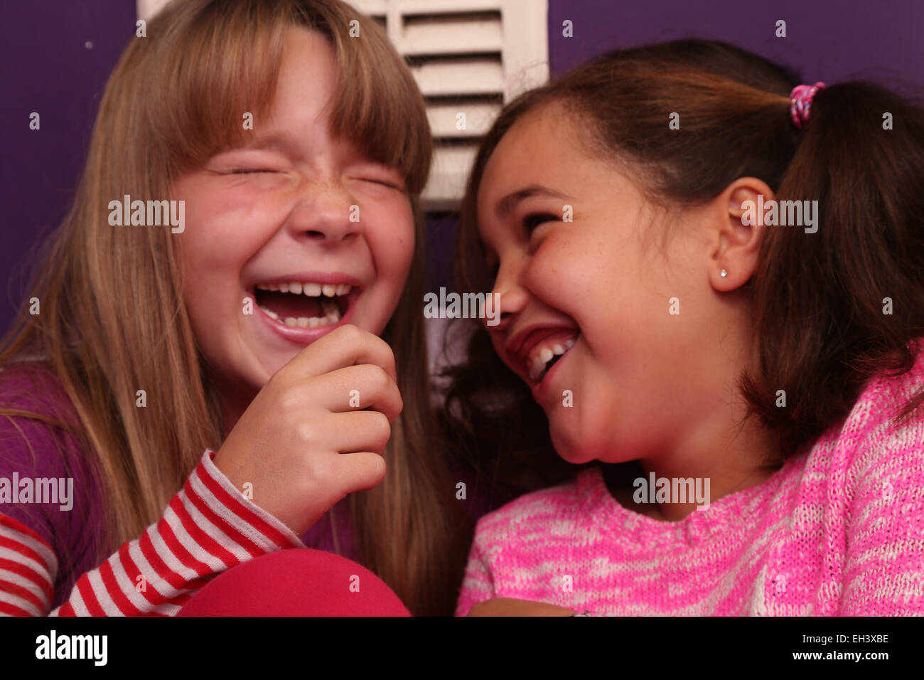 Young friends sharing a joke - model released Stock Photo - Alamy