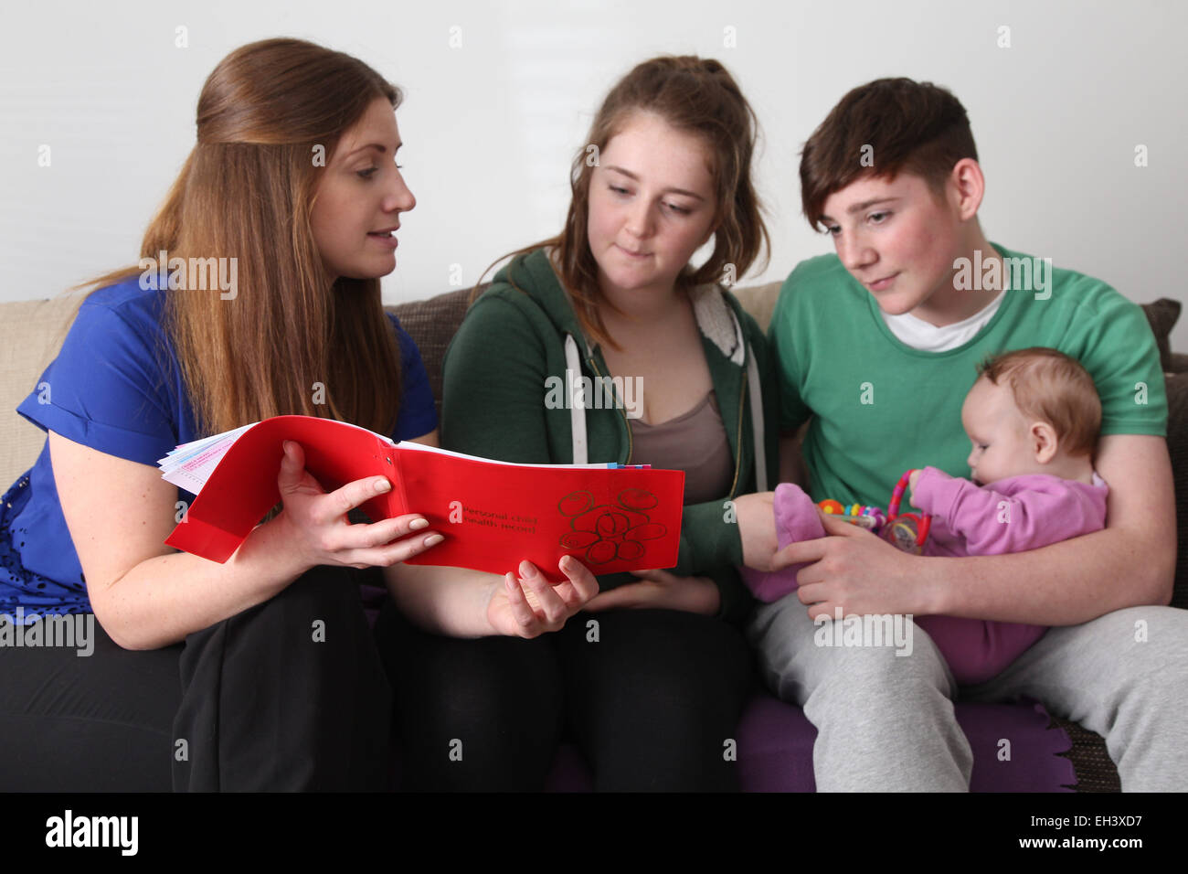 Health visitor visiting teenage couple with baby - model released Stock ...