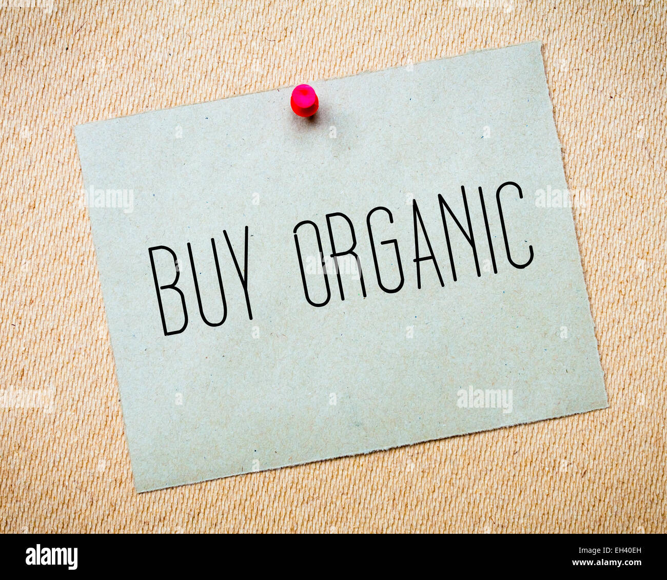 Recycled paper note pinned on cork board.Buy Organic Message. Concept ...