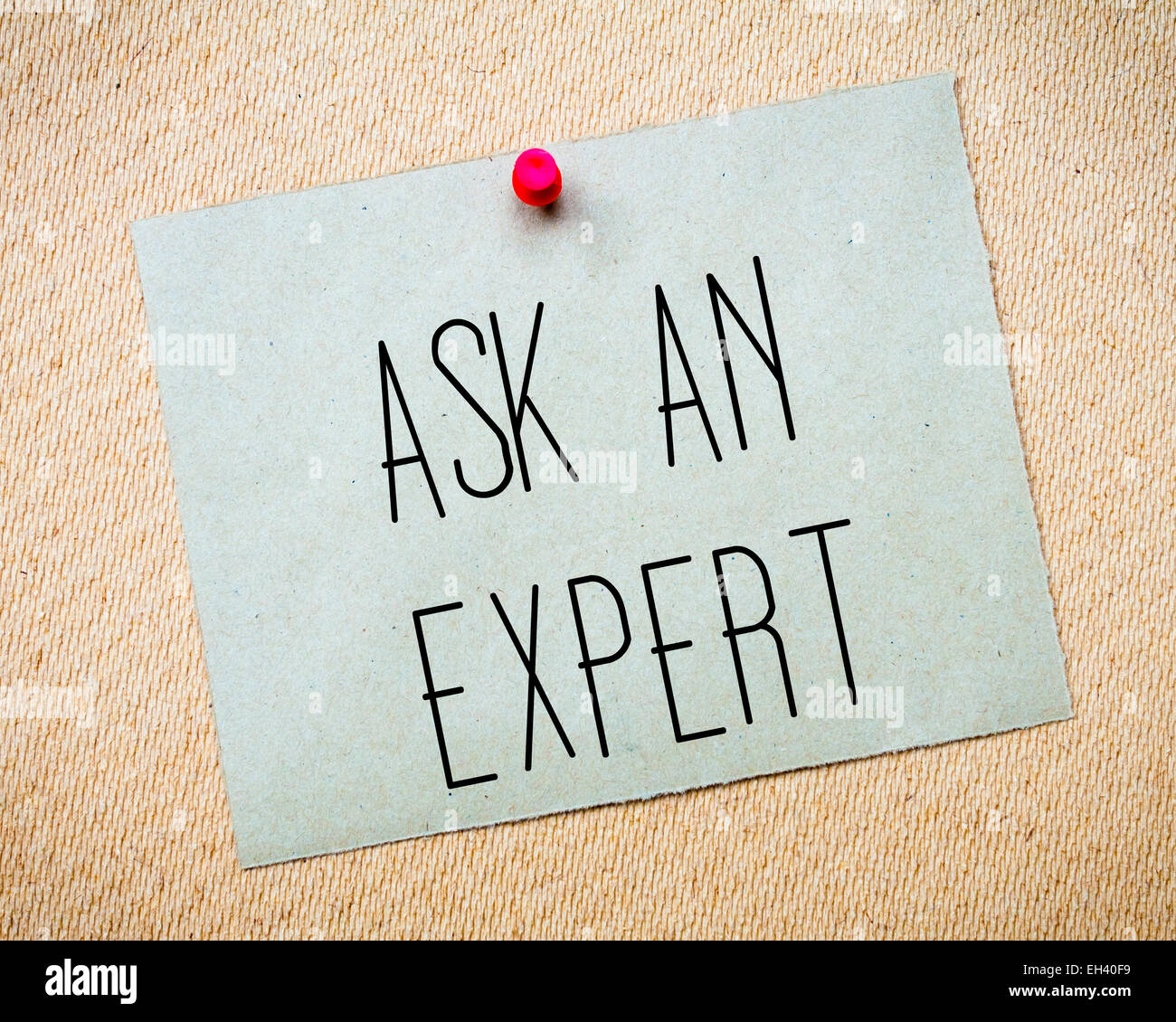 Recycled paper note pinned on cork board.Ask an Expert Message. Concept ...