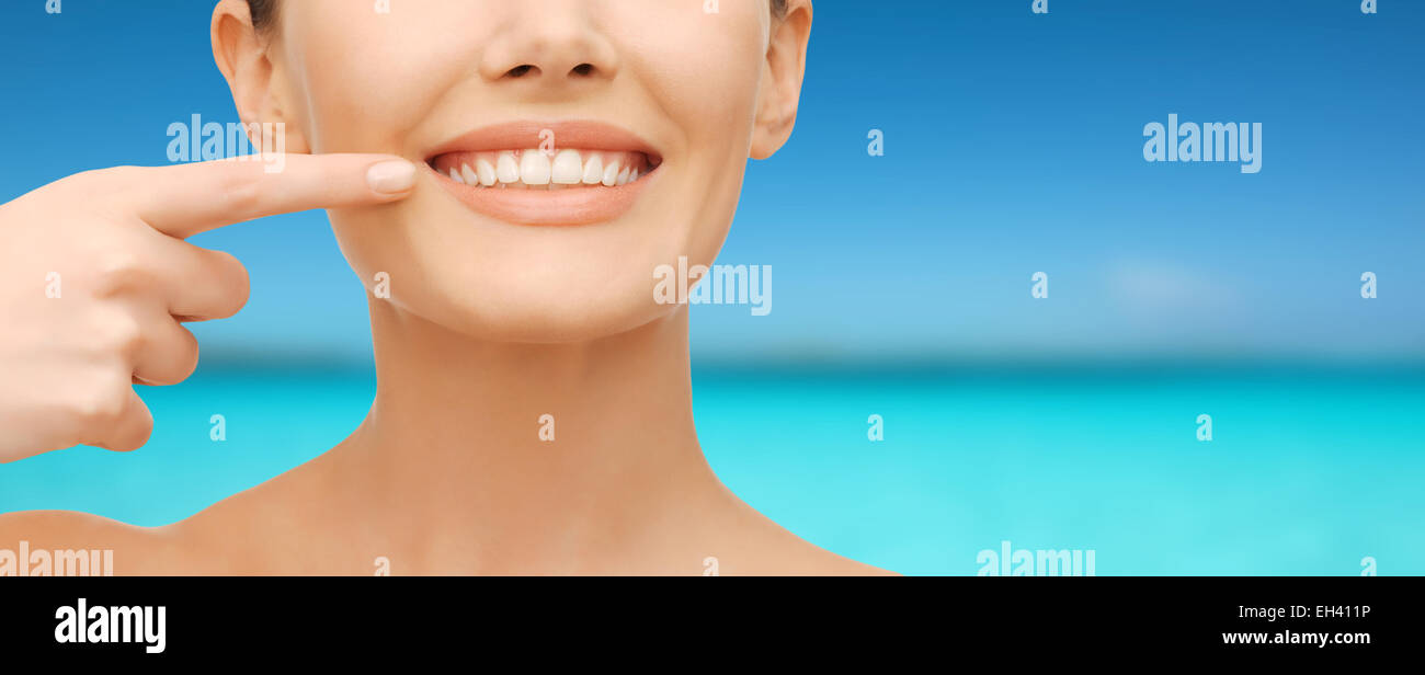 beautiful woman pointing to teeth Stock Photo - Alamy