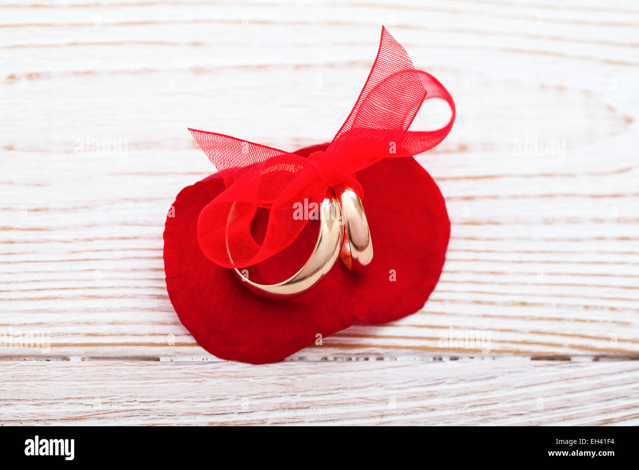Wedding decoration rings with red ribbon Stock Photo - Alamy