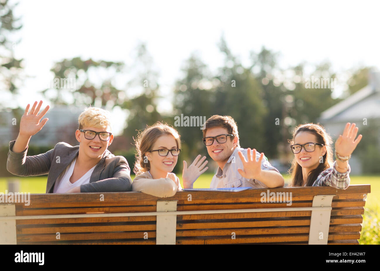 group of students or teenagers waving hands Stock Photo - Alamy