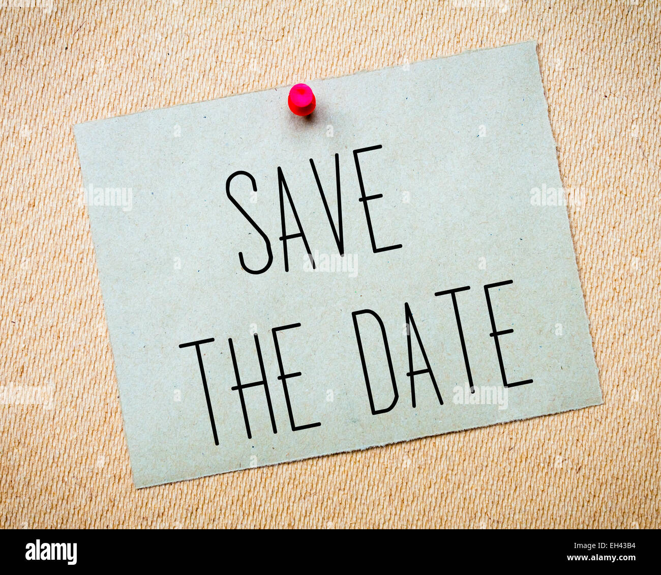 Recycled paper note pinned on cork board.Save the Date Message. Wedding ...