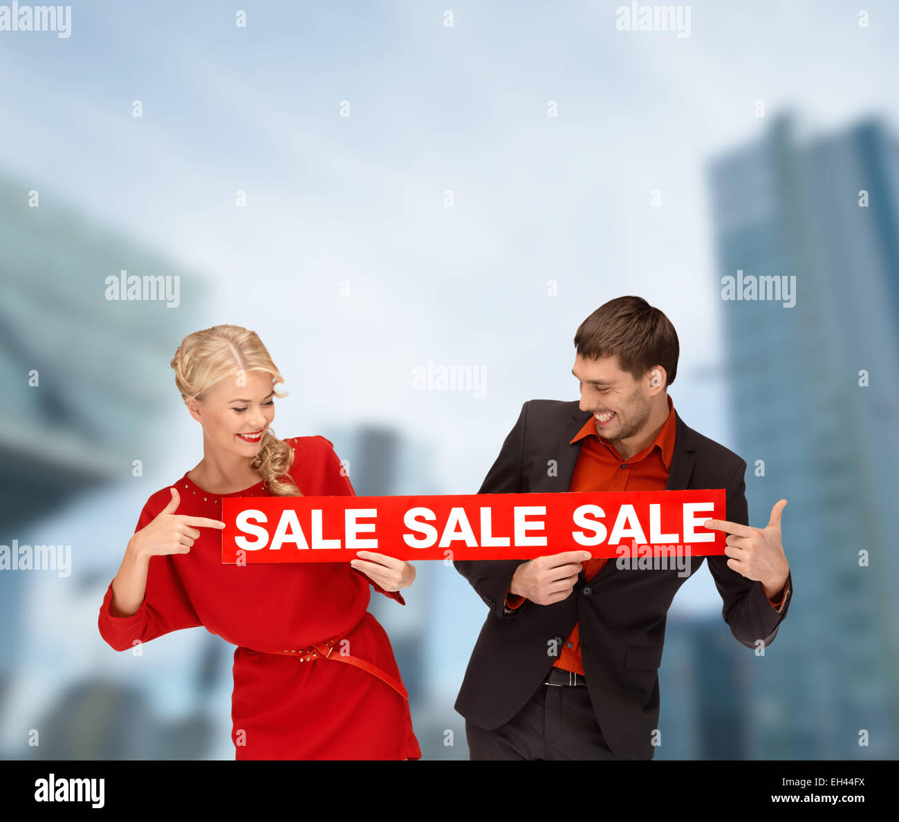 smiling woman and man with red sale sign Stock Photo - Alamy
