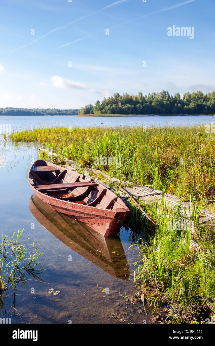 Fishing wooden boat at the lake in summer day Stock Photo - Alamy