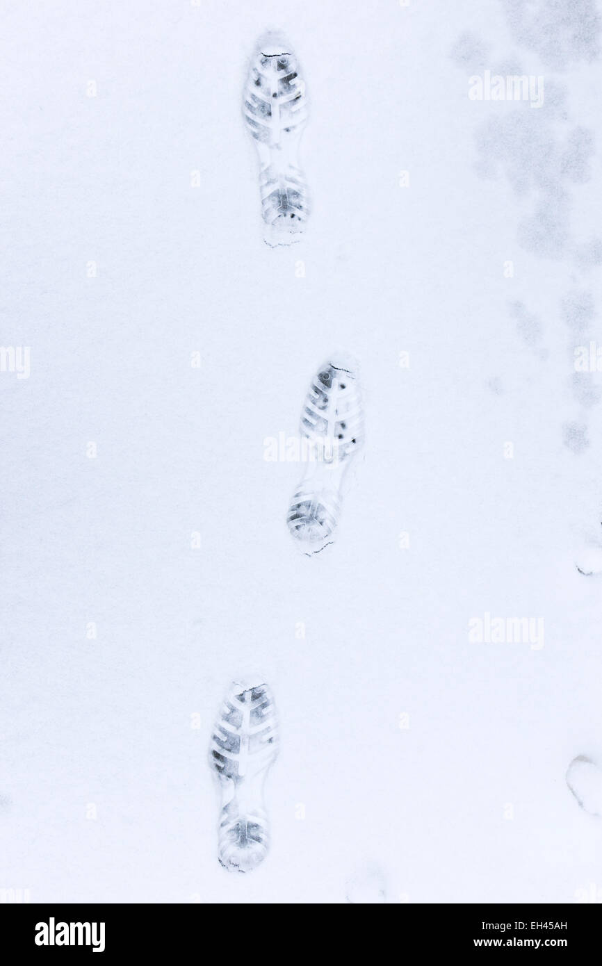 Footsteps on a snowy ground, viewed from above Stock Photo - Alamy