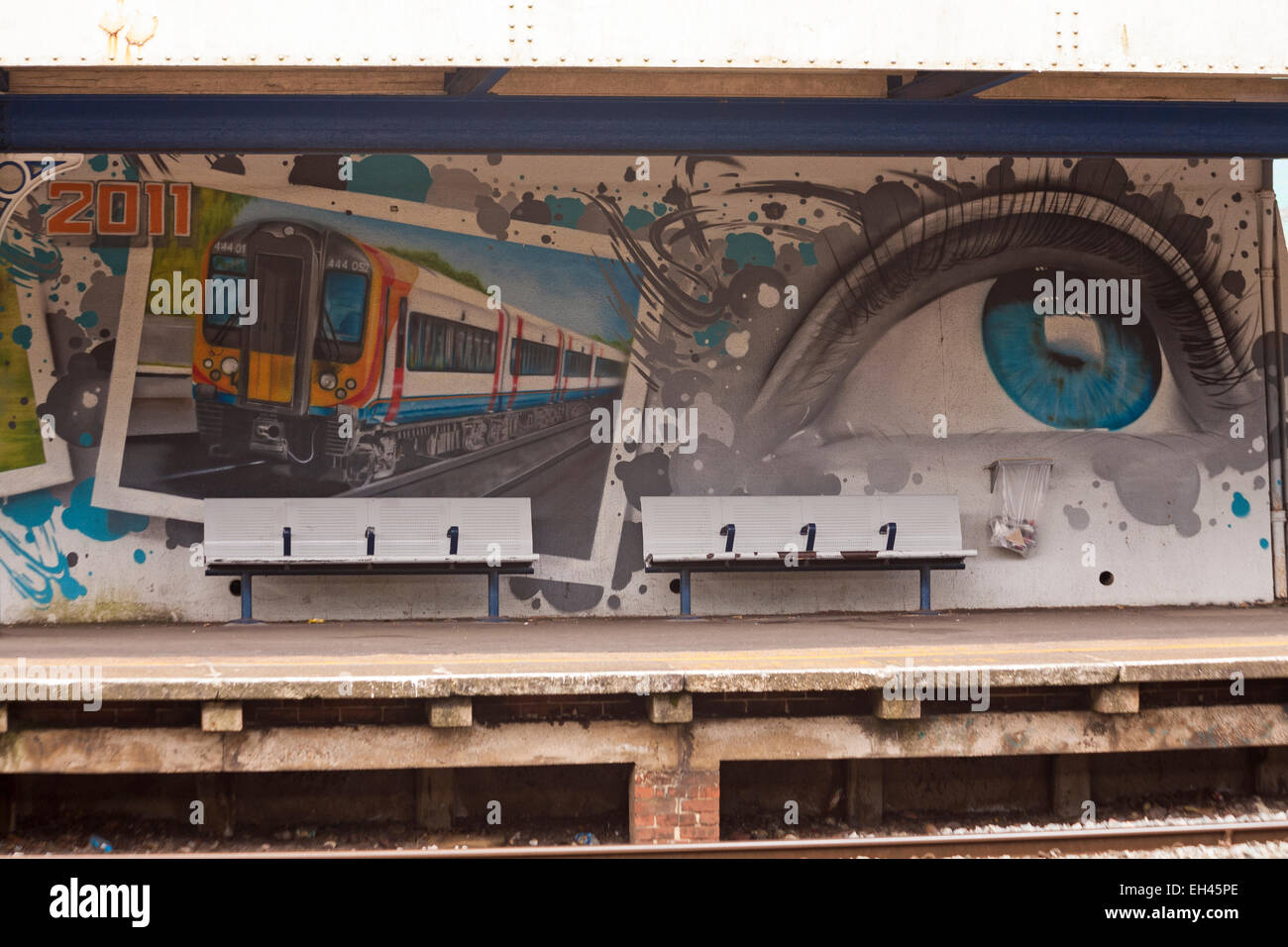 Artwork of murals of train and blue eye on walls of train station at ...