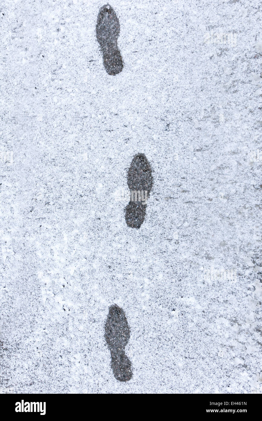 Footsteps on a snowy asphalt, viewed from above Stock Photo - Alamy