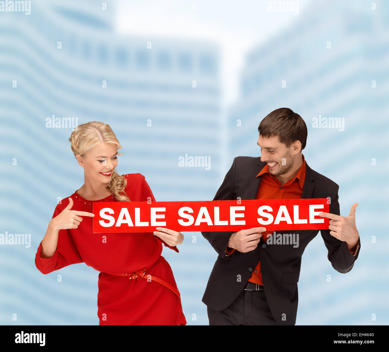 smiling woman and man with red sale sign Stock Photo - Alamy