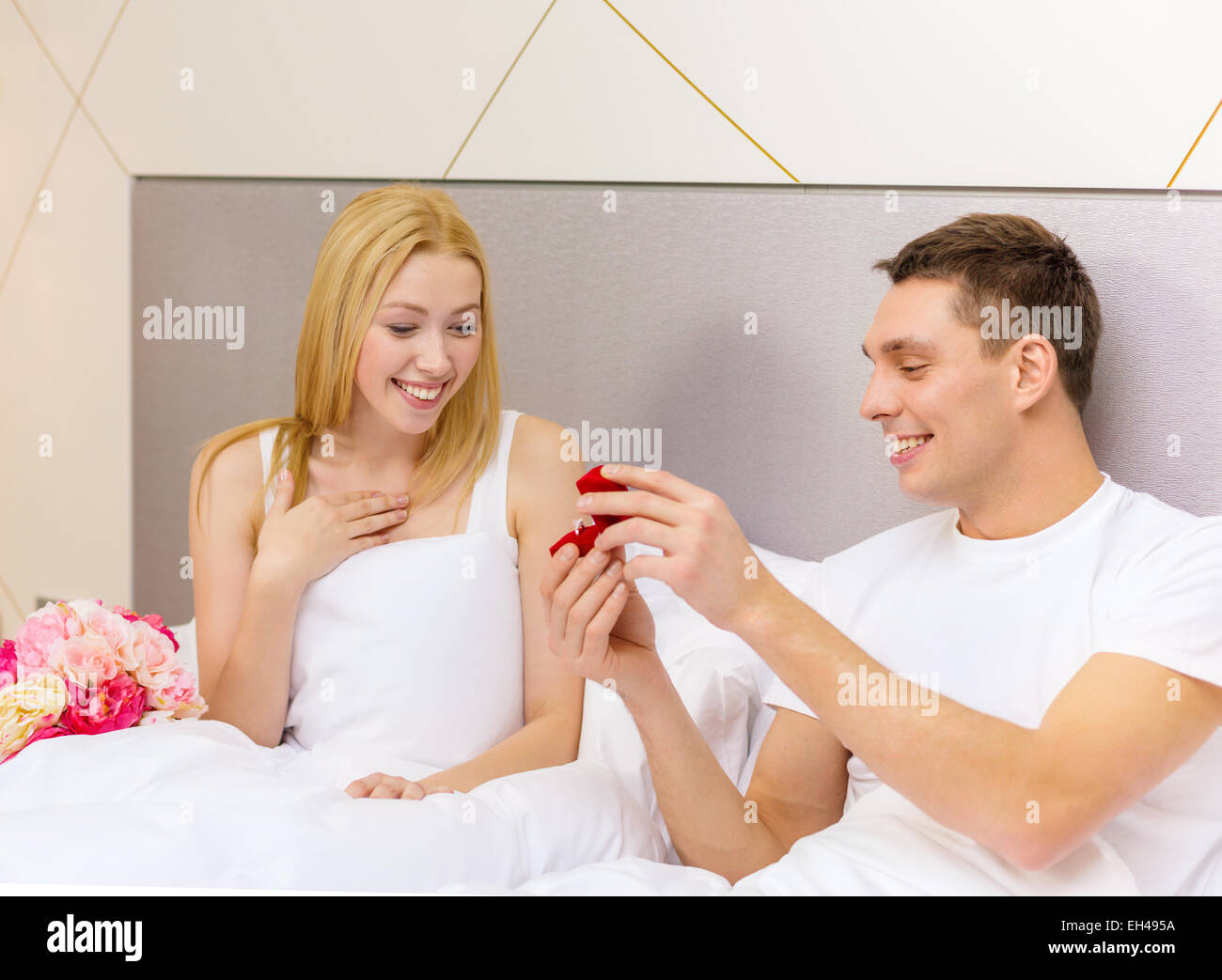 man giving woman little red box and ring in it Stock Photo - Alamy
