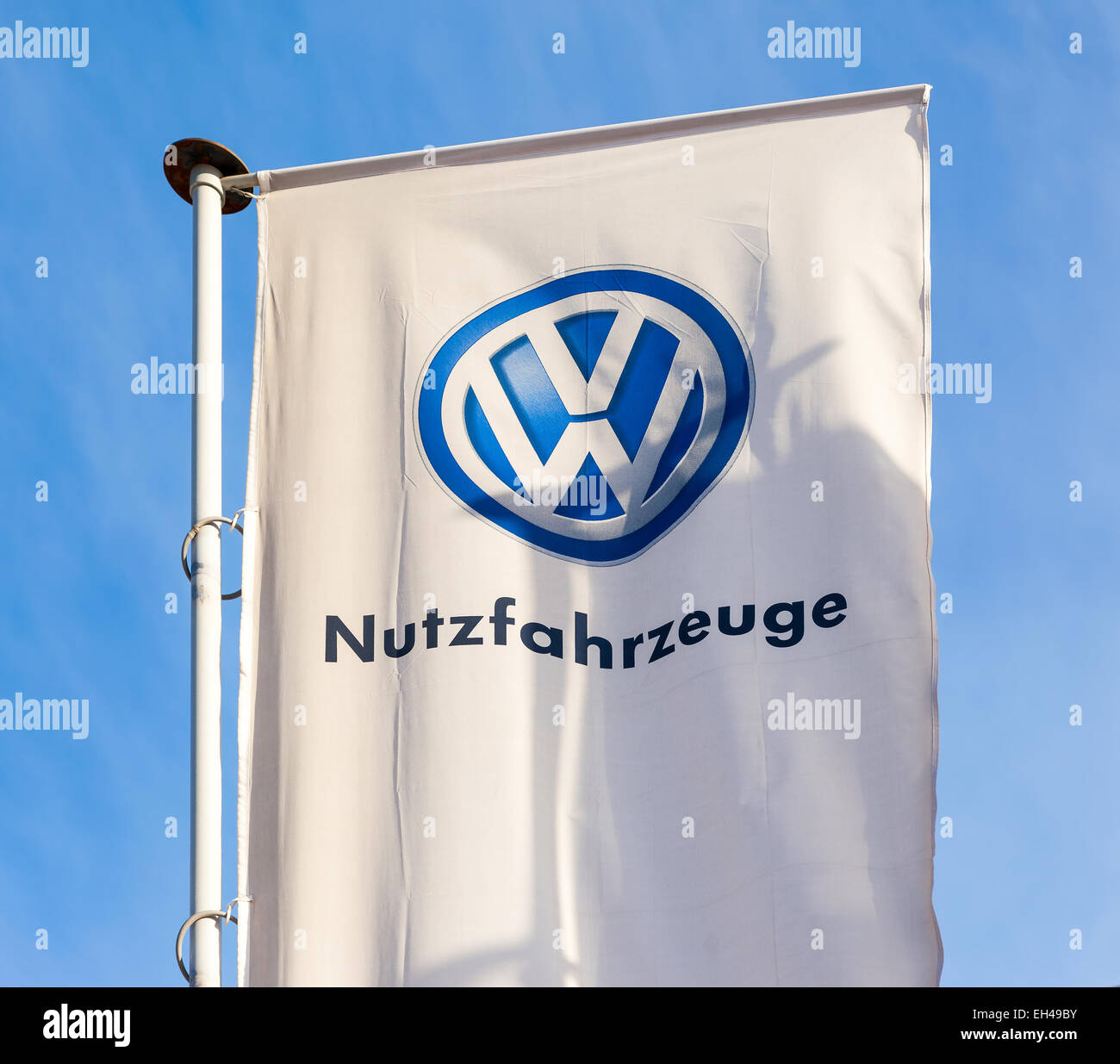The flag of Volkswagen over blue sky. Volkswagen is the biggest German ...