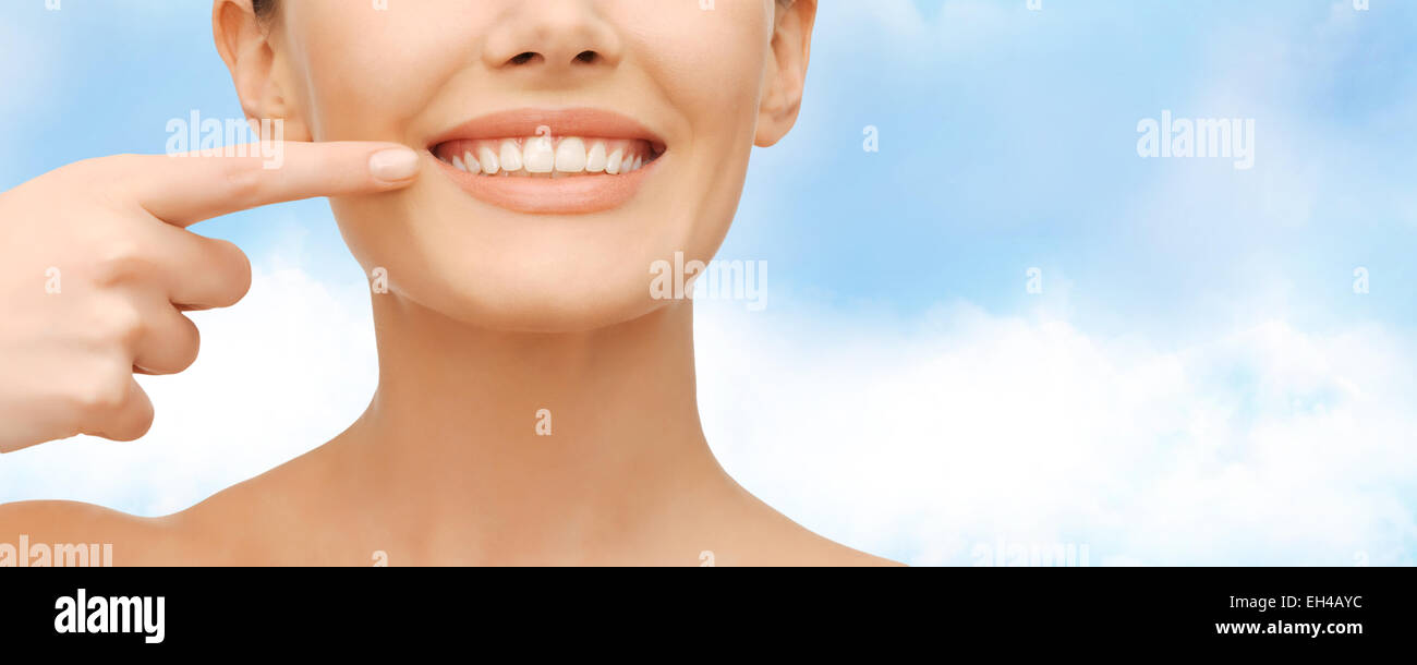 beautiful woman pointing to teeth Stock Photo - Alamy