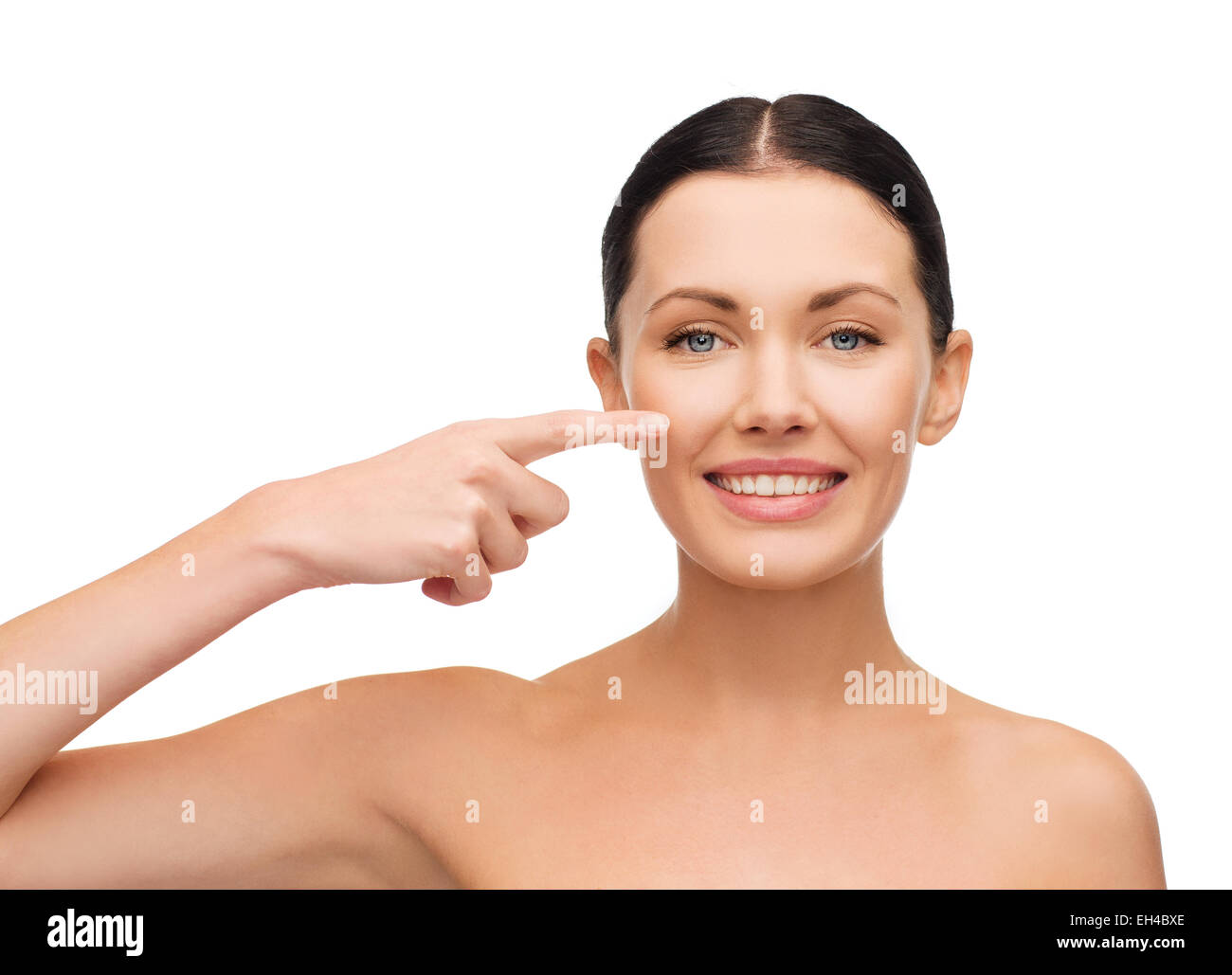 young calm woman pointing to her cheek Stock Photo - Alamy