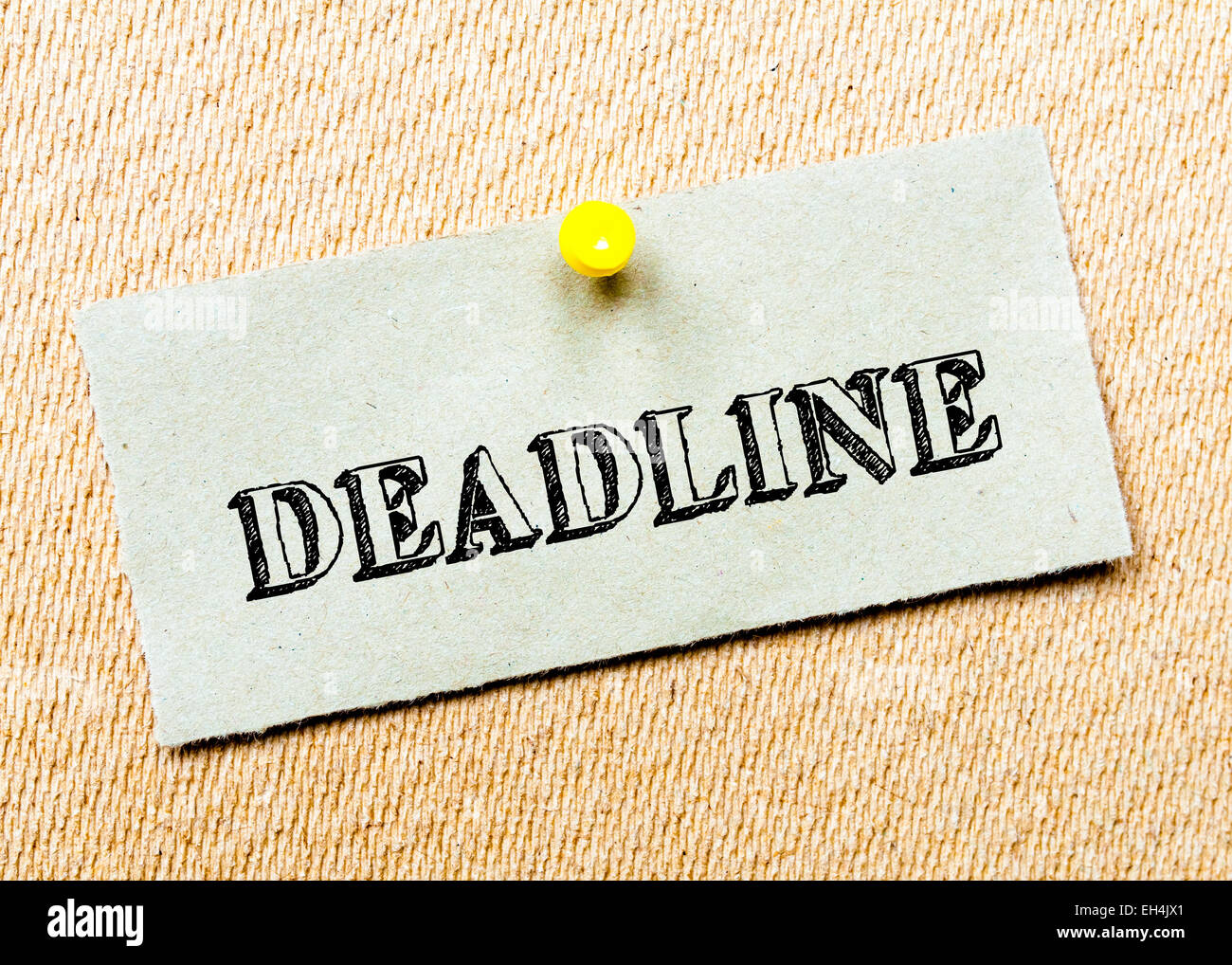Recycled paper note pinned on cork board. Deadline message. Concept ...