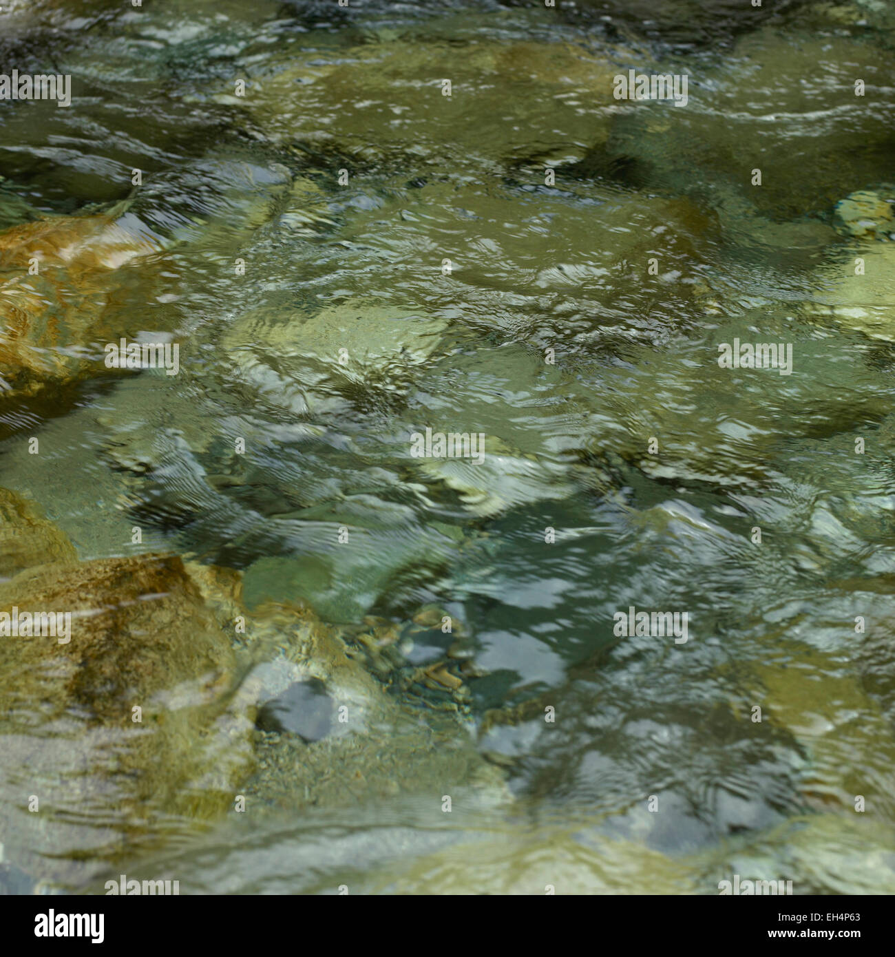 Close up of a river with clear water and stones Stock Photo - Alamy