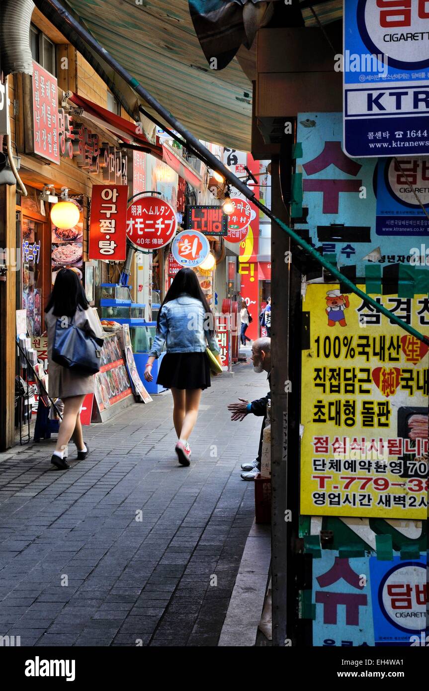South Korea, Seoul, woman in a small street in the city center in ...