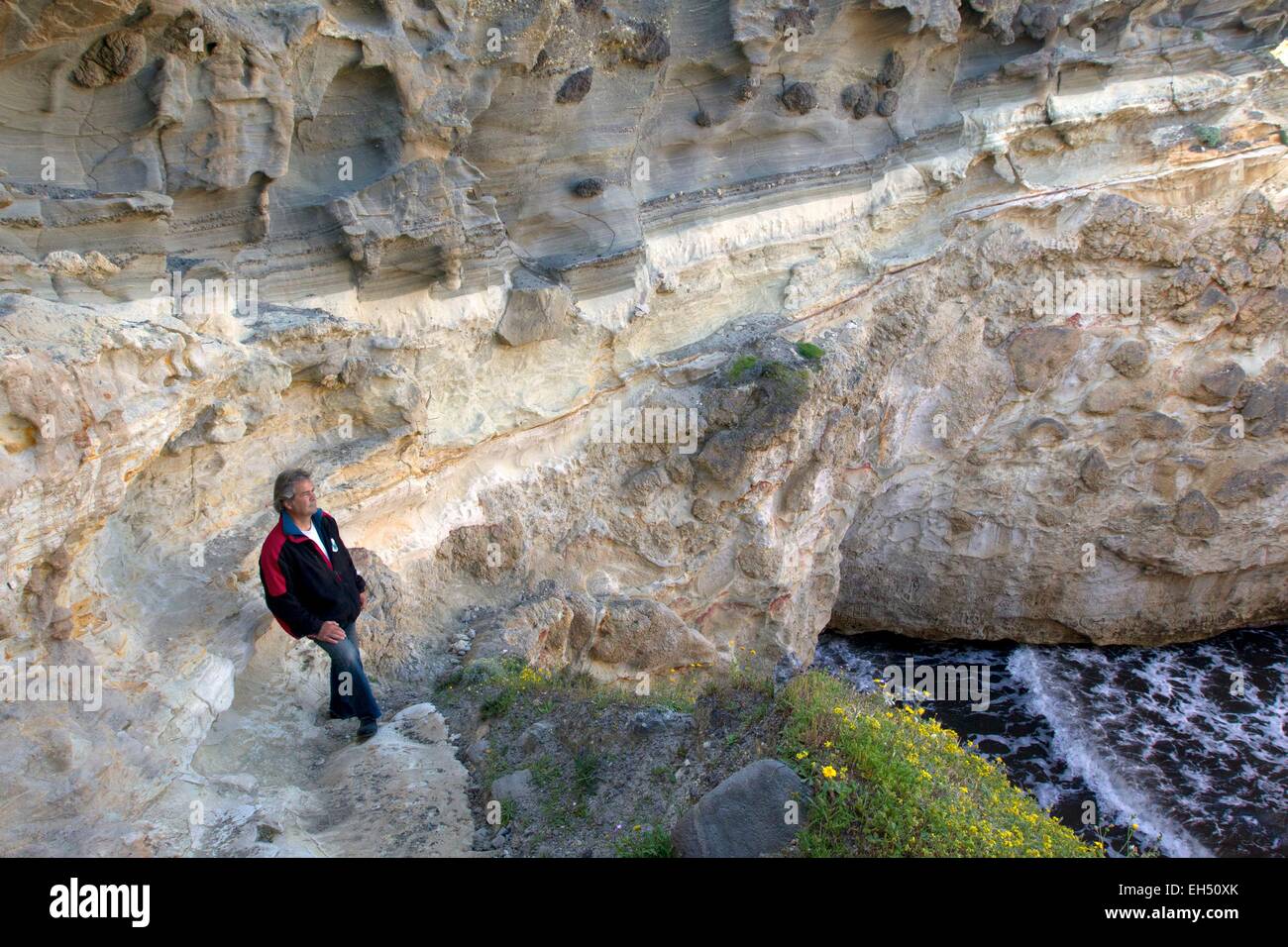 Greece, Cyclades, Island of Milos, Pachena, Yannis before a seal cave ...