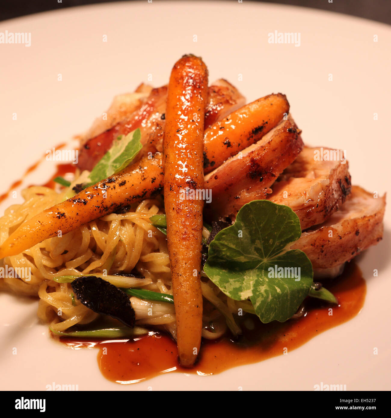 A plate of saddle of rabbit wrapped in pancetta, braised leeks ...