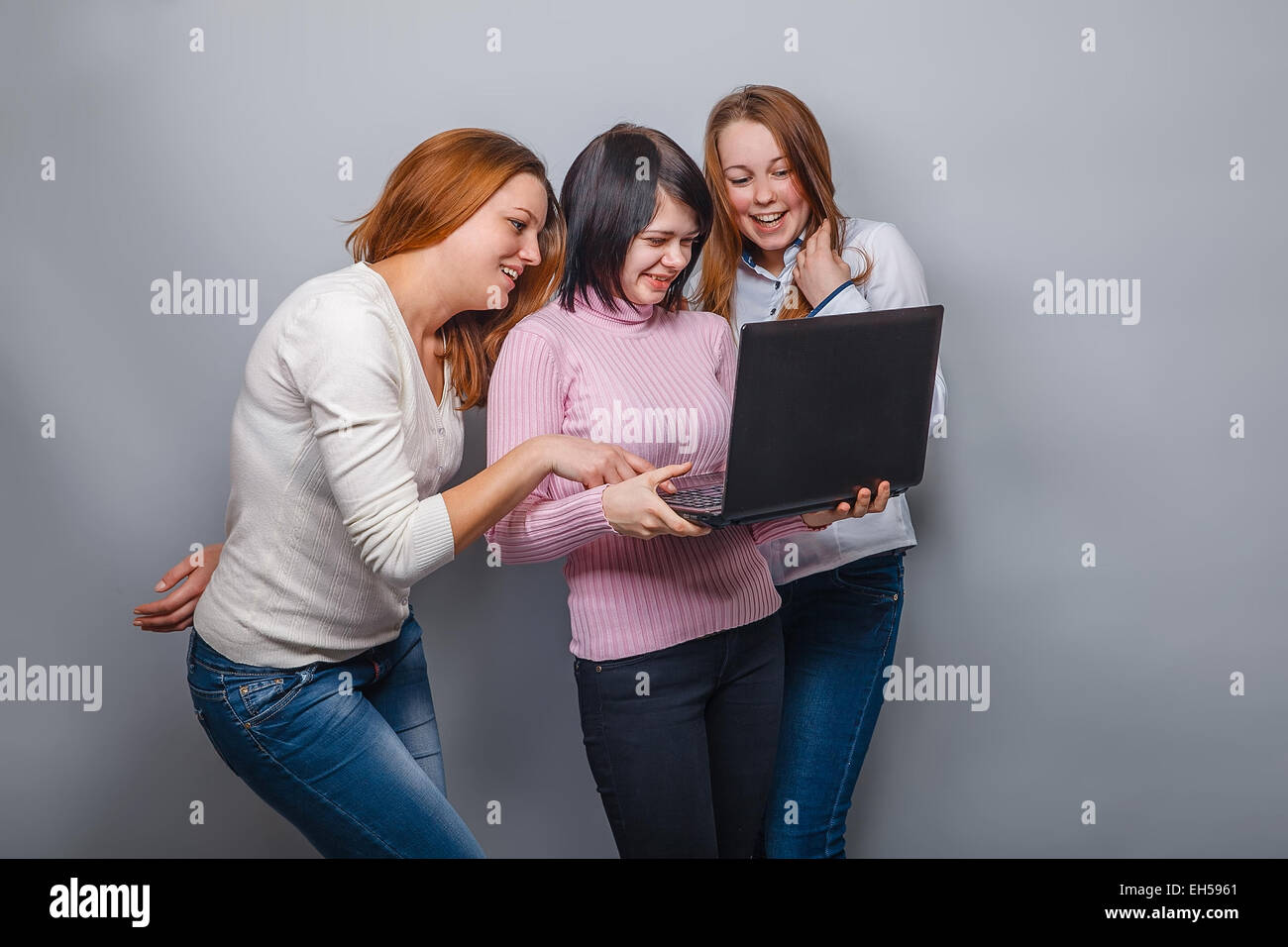 Three girls European appearance girlfriend working at the computer and ...