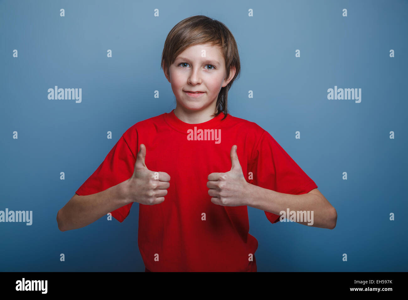boy teenager European appearance in a green T-shirt showing sign yes on ...