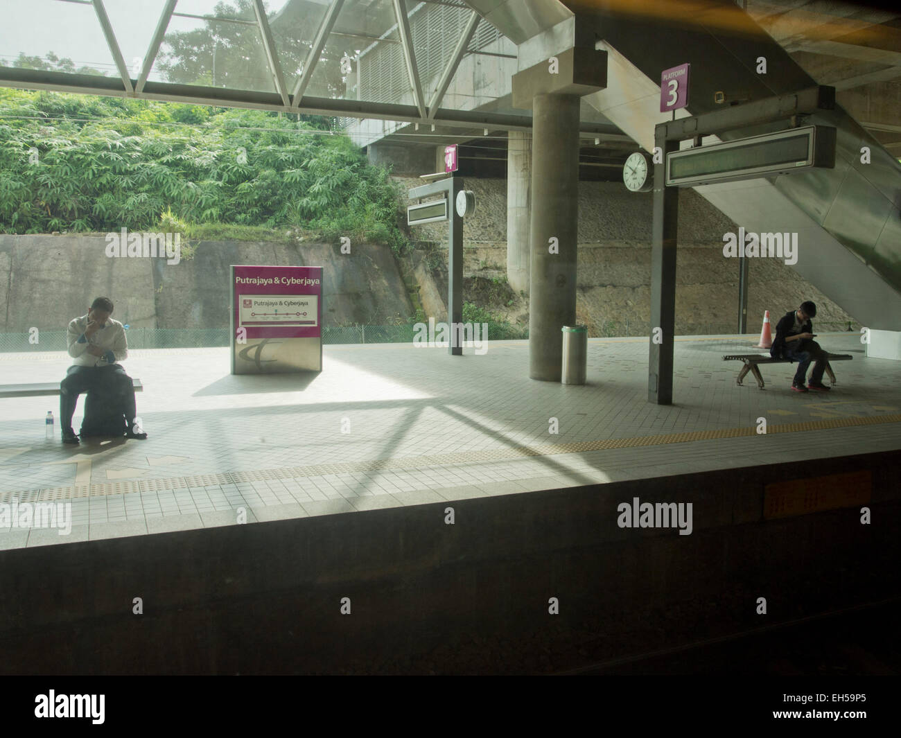 Passengers on a station along route of fast shuttle train from Kuala ...