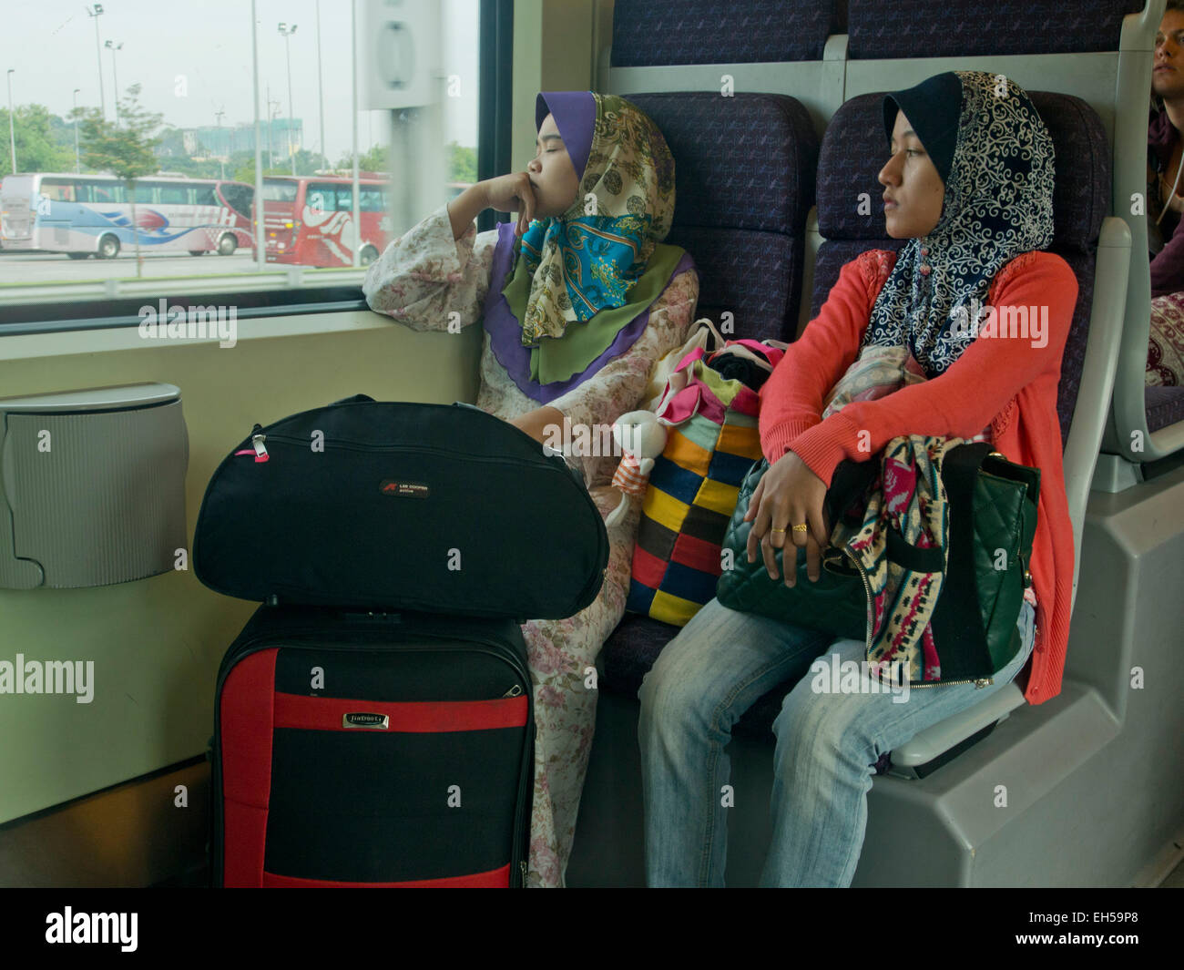 Passengers on fast shuttle train from Kuala Lumpur international ...