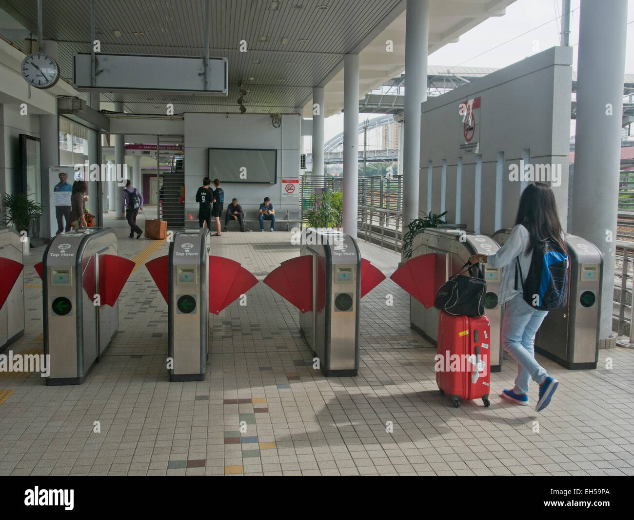 Passengers on station along route of fast shuttle train from Kuala ...