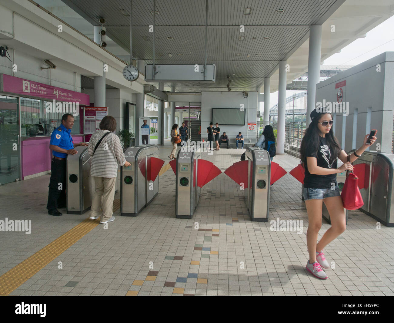 Passengers on station along route of fast shuttle train from Kuala ...
