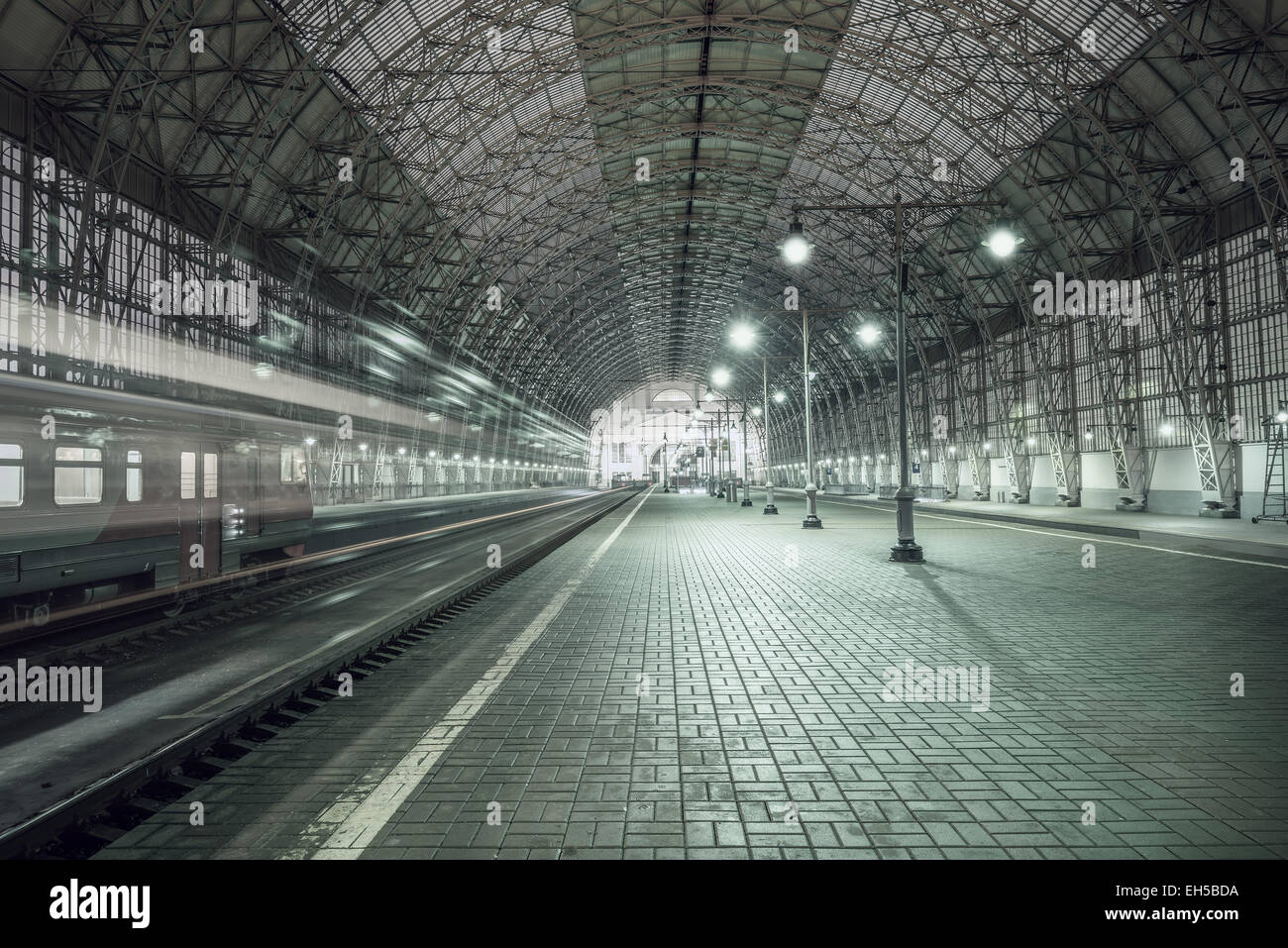 High speed train departs from the station at night time Stock Photo - Alamy