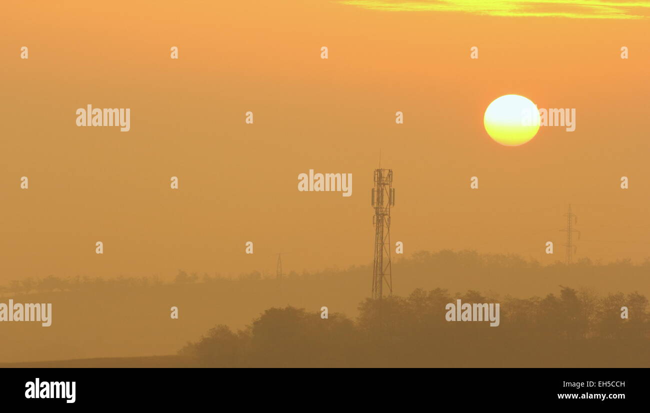 Sun rising over the mist in a wild area. Environmental damage made by ...