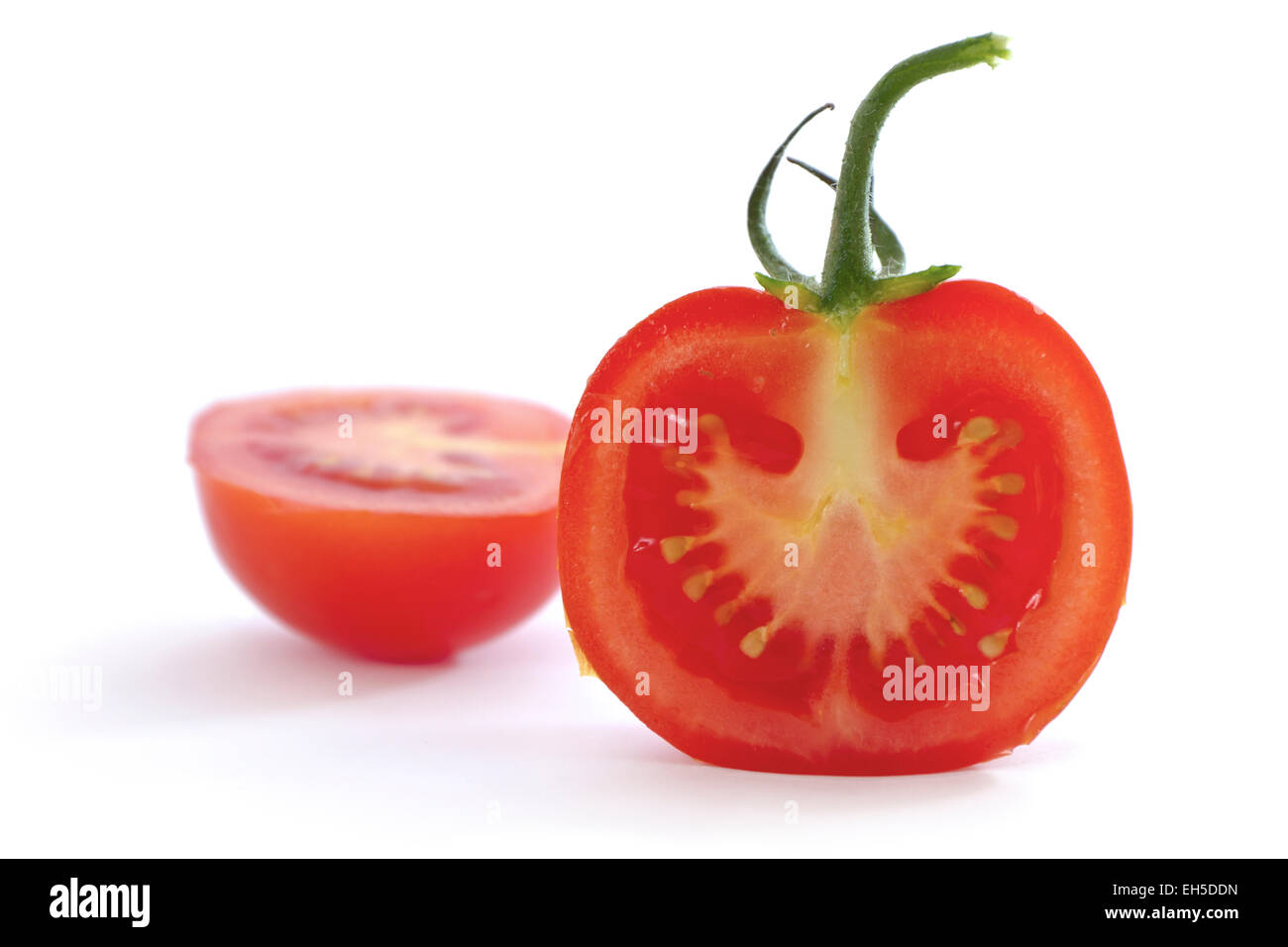 Side view of a fresh sliced organic tomato on white background Stock ...