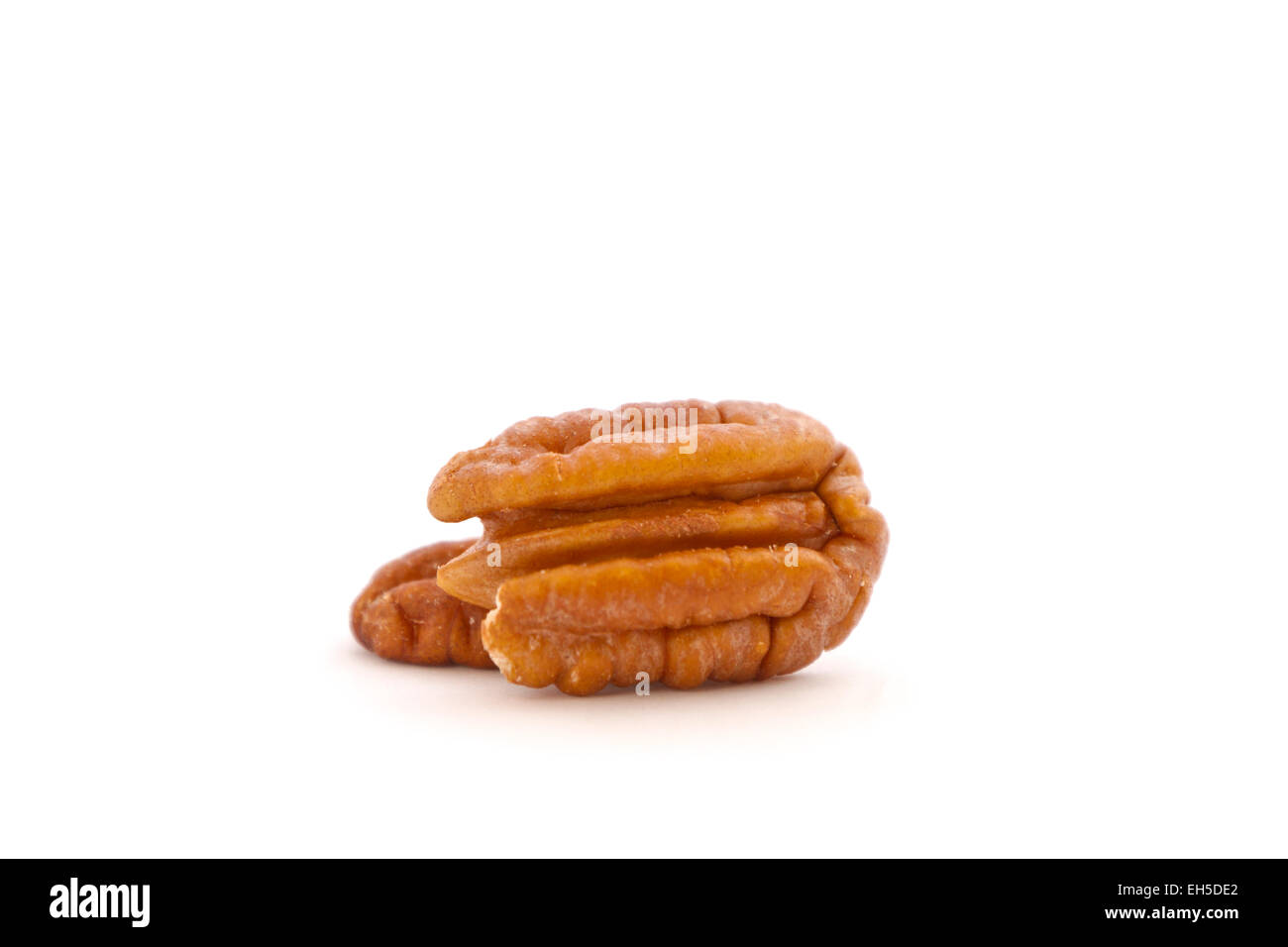 Side view of a pile of organic pecans / nuts on white background Stock ...
