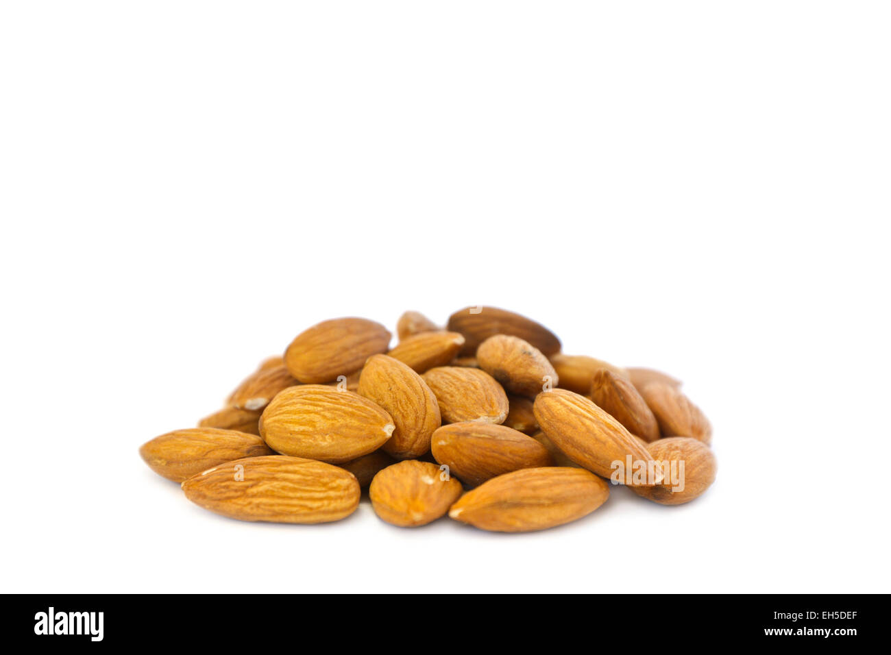 Side view of a pile of organic almonds on white background Stock Photo ...