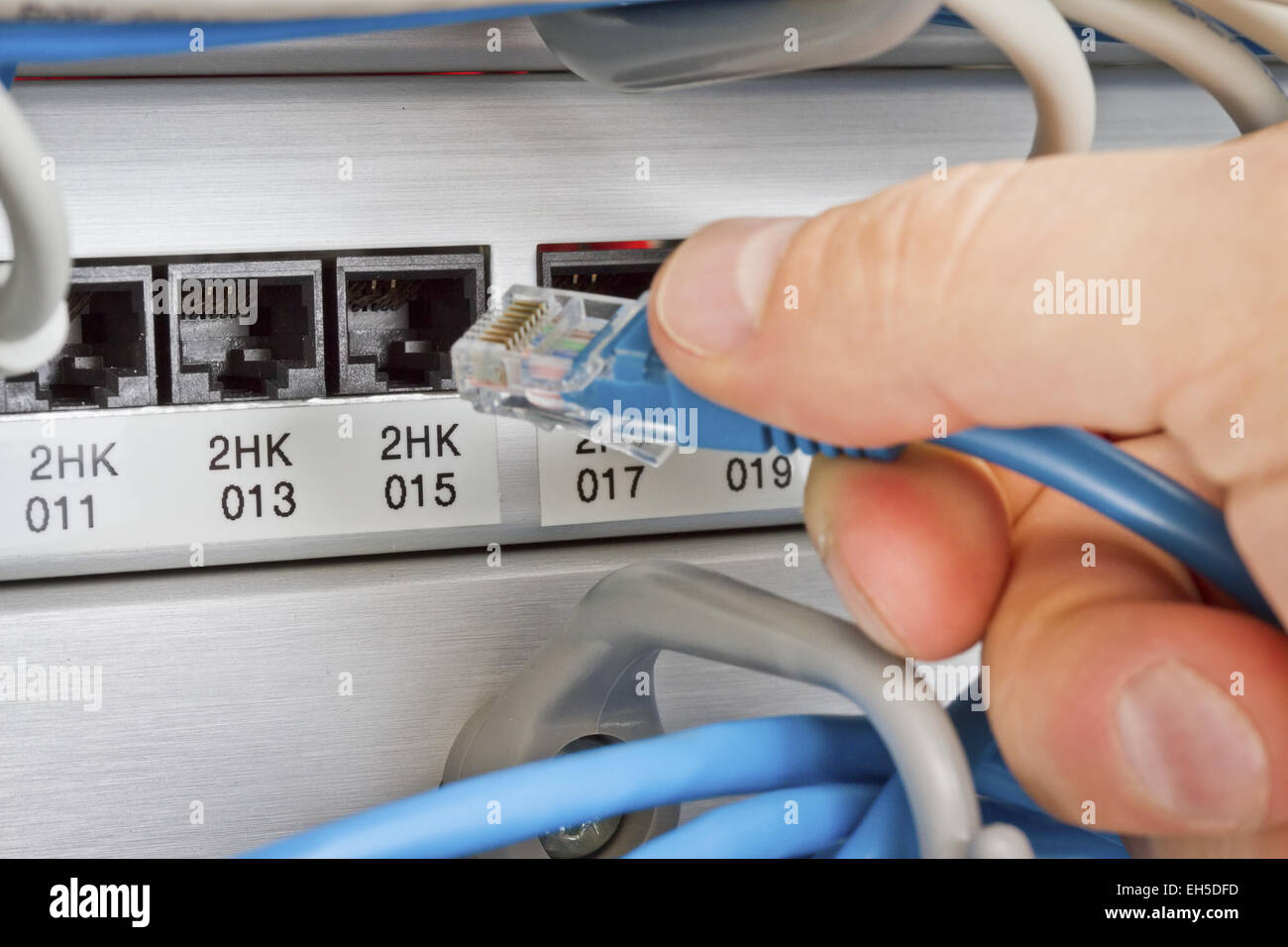 Close up of a IT consultant inserting / connecting a network ...