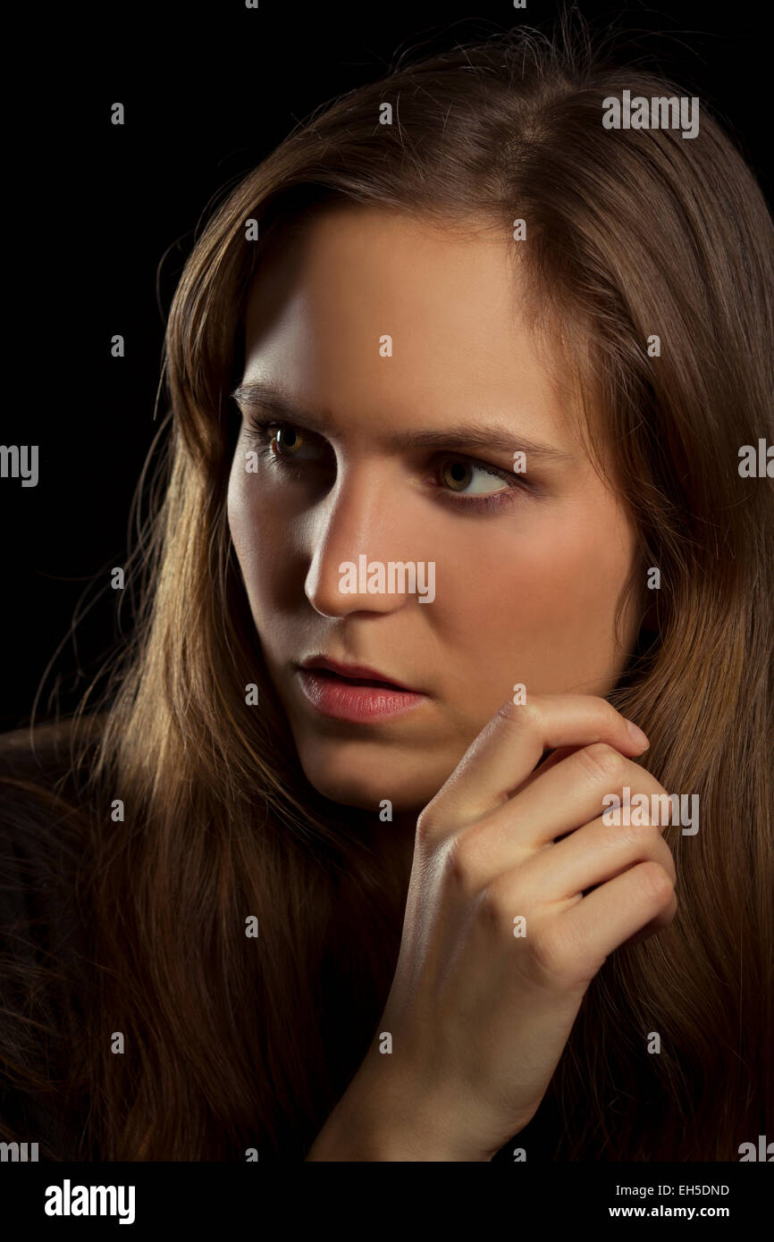 Studio shot of a young woman / girl with lowkey lighting. Black ...