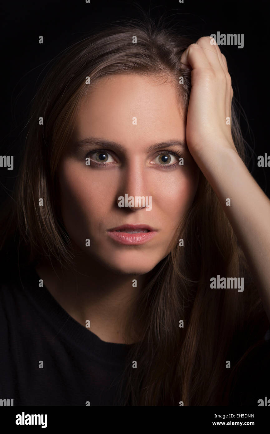 Studio shot of a young woman / girl with lowkey lighting. Black ...