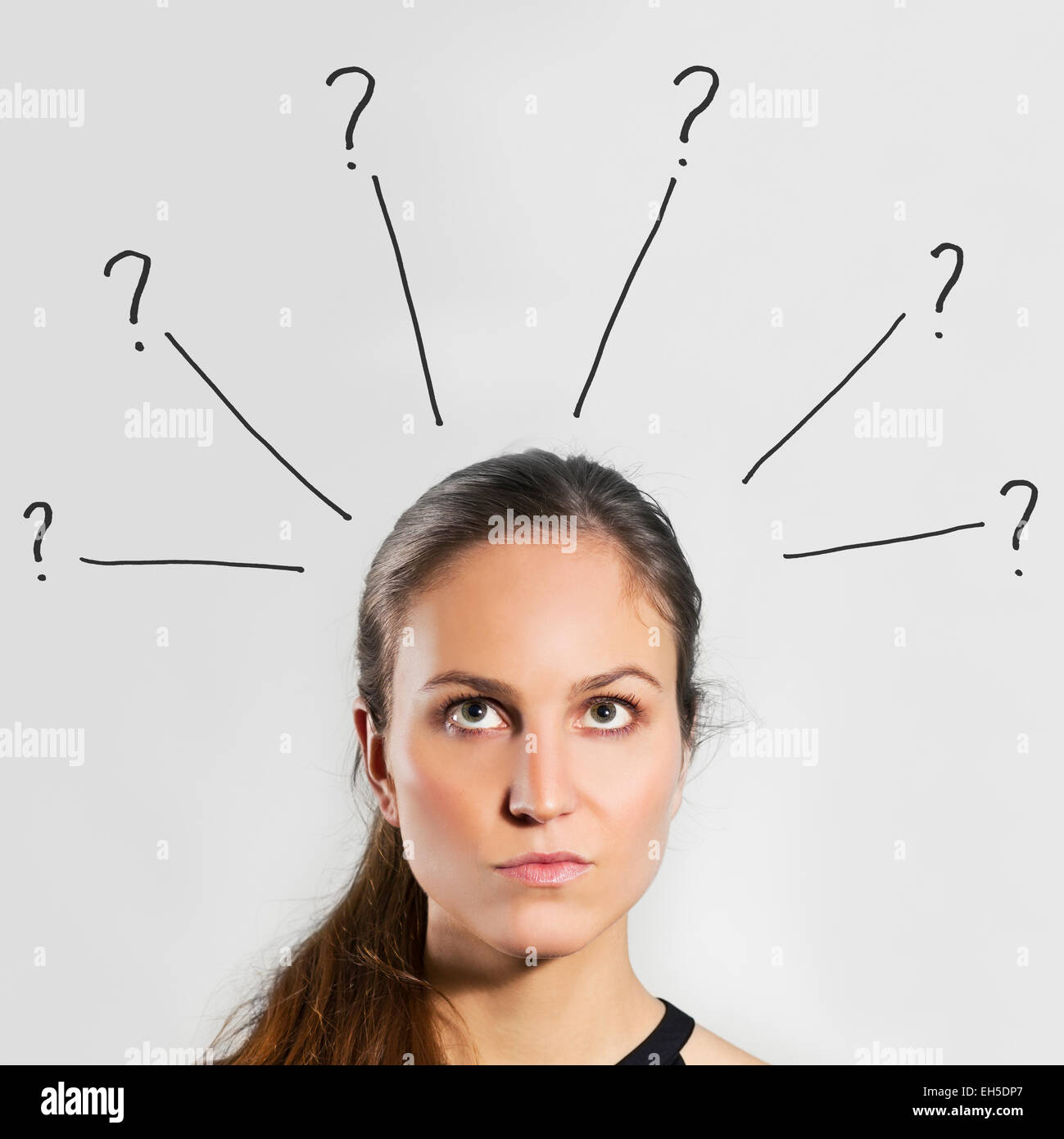 Young woman / girl thinking / wondering with gray background. Question ...