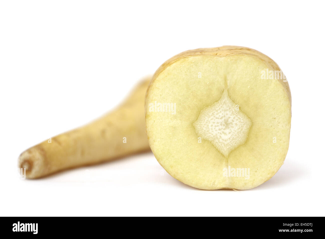 Organic and fresh Parsley Root cut in two on white background Stock ...