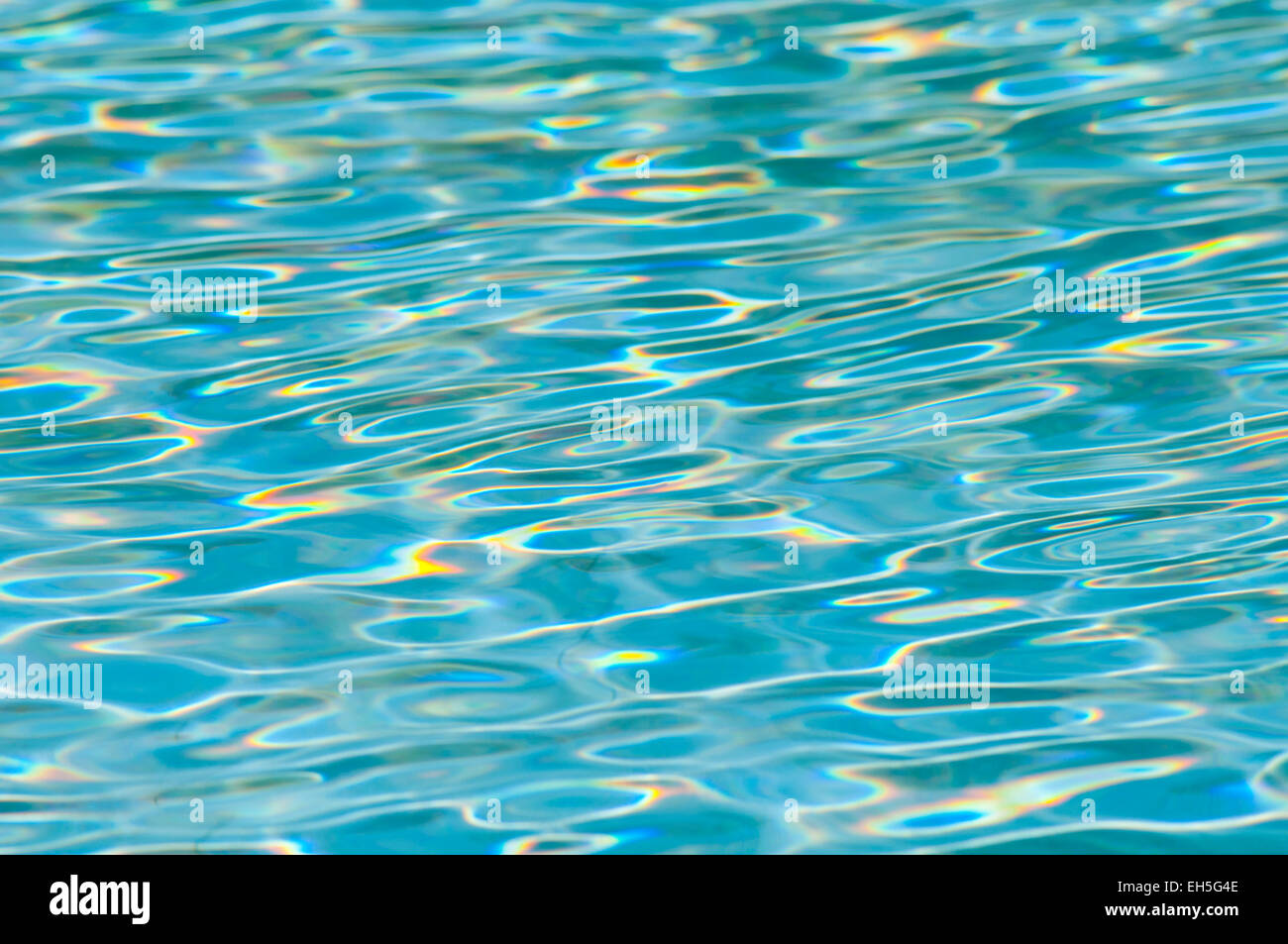 Colorful ripples on the surface of swimming pool water, soft focus ...