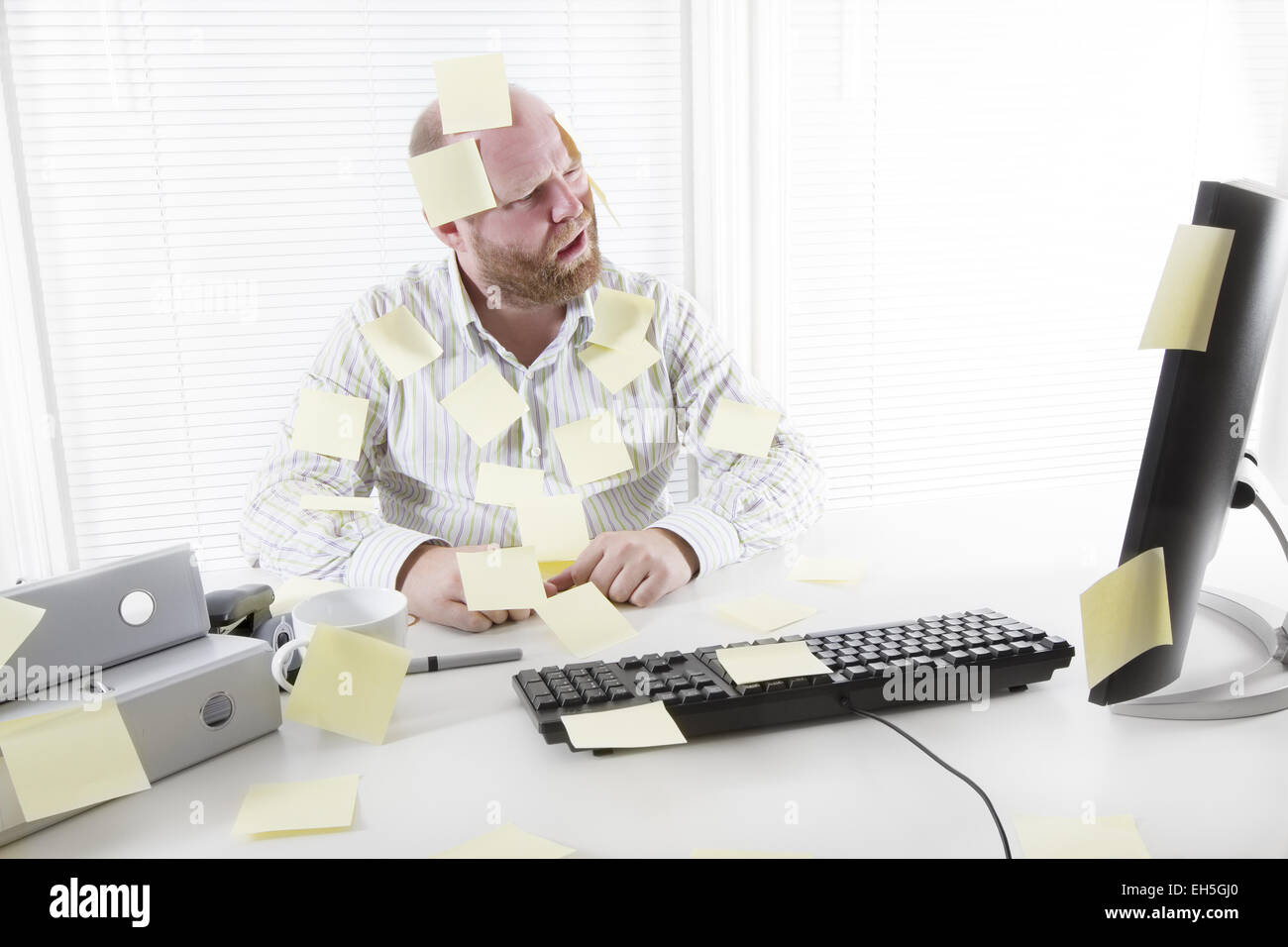 Exhausted and tired office worker in the office. To much work and no ...