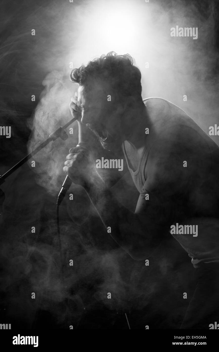 Young man playing rock concert. sings and play guitar Stock Photo - Alamy