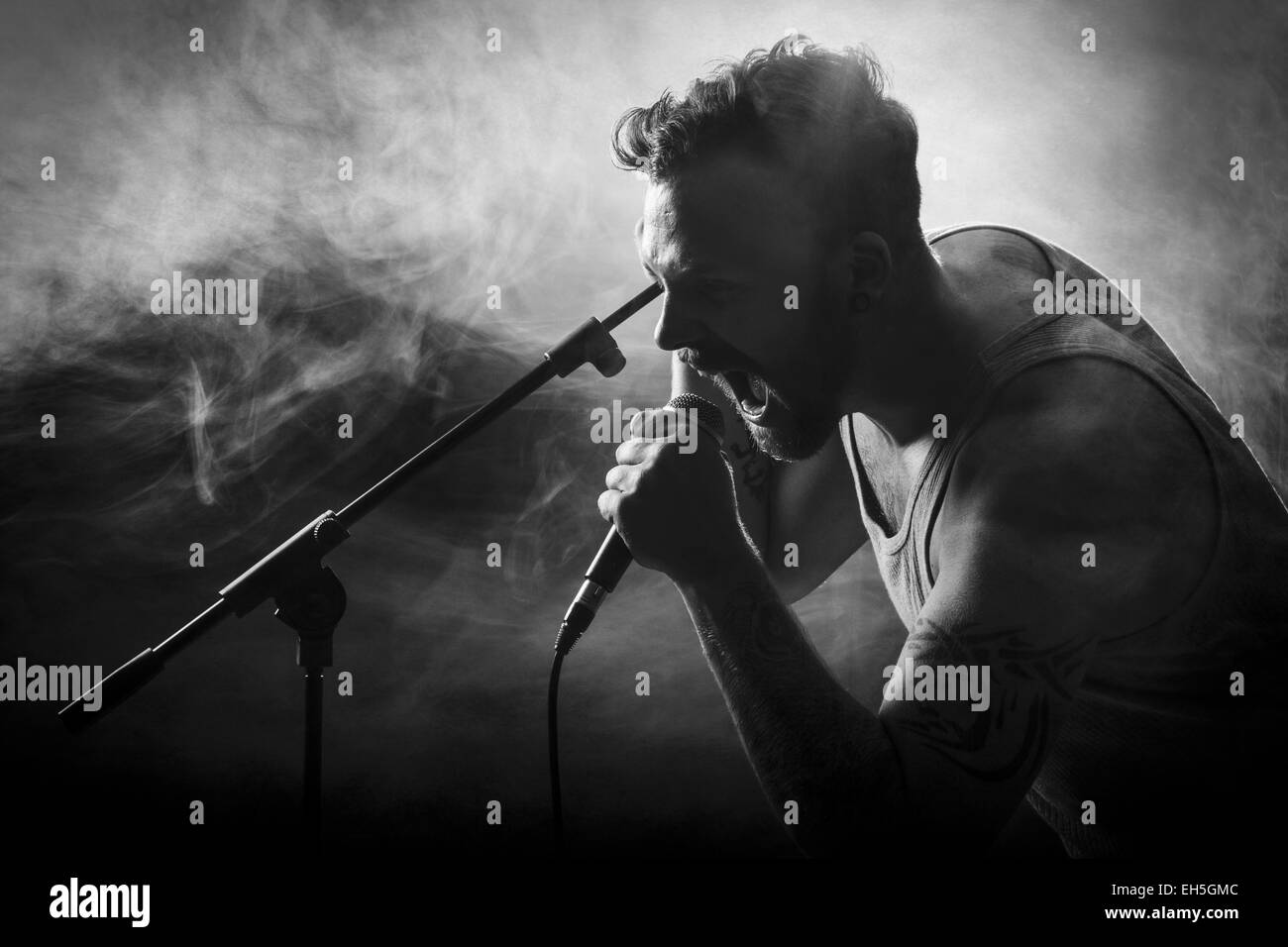 Young man sing / growls in hard rock concert Stock Photo - Alamy