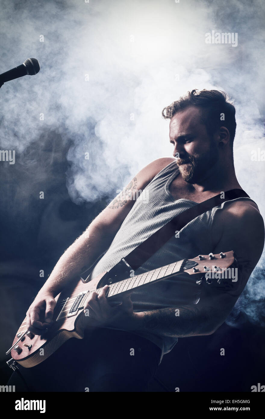 Young man playing rock concert. sings and play guitar Stock Photo - Alamy