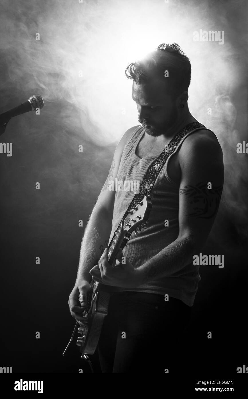 Young man playing rock concert. sings and play guitar Stock Photo - Alamy