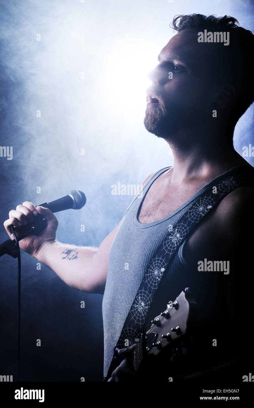 Young man playing rock concert. Play guitar Stock Photo - Alamy